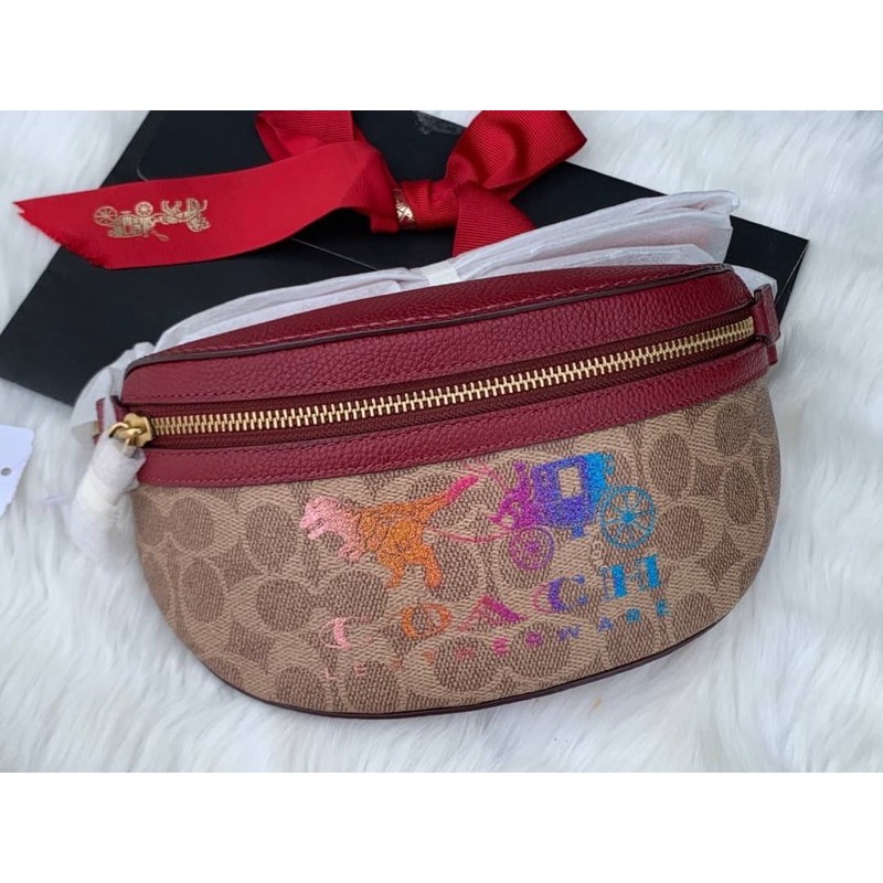 (ผ่อน0%) กระเป๋าคาดอก Coach Belt Bag in Signature Canvas With Rexy and ...