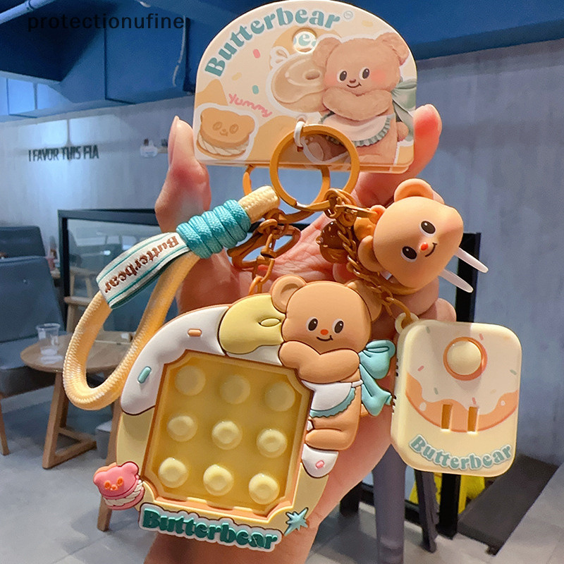 Prne Butterbear ซ็อกเก็ตของเล่นพวงกุญแจหญิงน่ารักหมีเนยการ์ตูน Deion ...